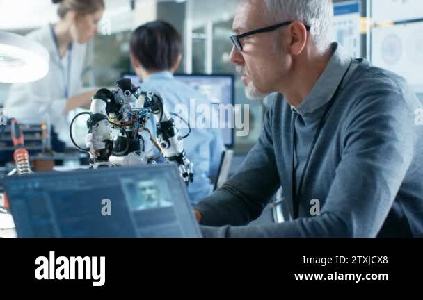 Senior Robotics Engineer Manipulates Voice Controlled Robot, Laptop ...