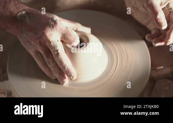 Traditional pottery making, man teacher shows the basics of pottery in ...