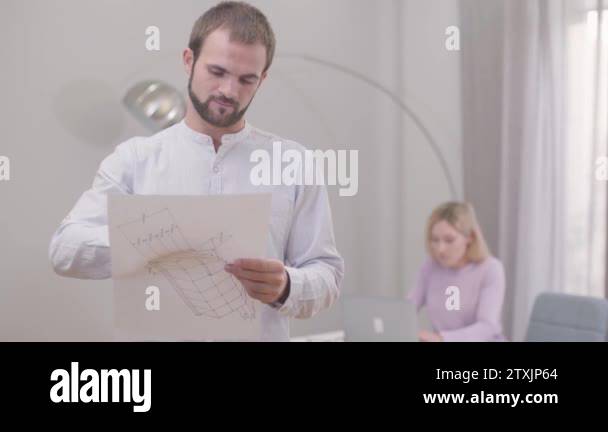 Portrait of confident satisfied Caucasian designer looking through his ...