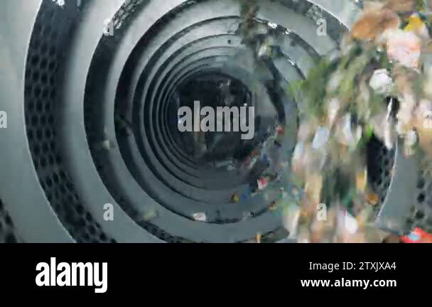 Garbage falls from a conveyor into a machine Stock Video Footage - Alamy