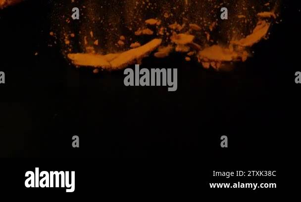Turmeric, curcuma longa, Powder falling against Black Background ...