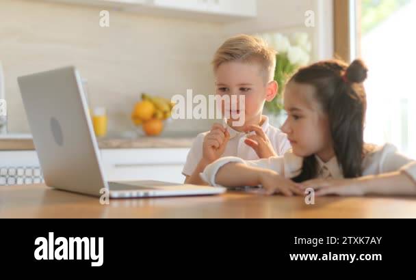 Two happy children playing with laptop. Kids or friends with computer ...