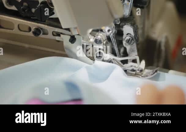 Womans hands sewing an overlock at sewing machine. Overlock stitch on ...