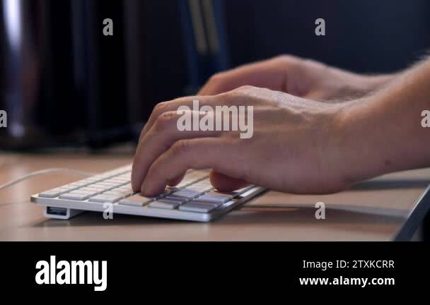 Mans hand with smart watch close up type at desktop keyboard in ...