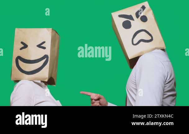 The concept of emotions and gestures. Two people in paper bags with ...