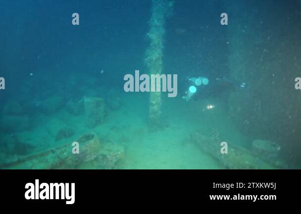Diver on sunken ship inside view on wreck underwater in Truk Lagoon ...