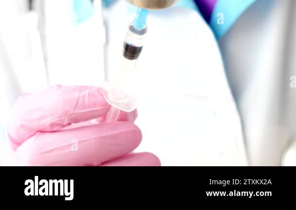 Medical doctor picking up medication into a single use syringe Stock ...