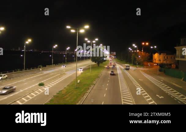 Multiband highway in big city with going cars in night. Cars drive on ...