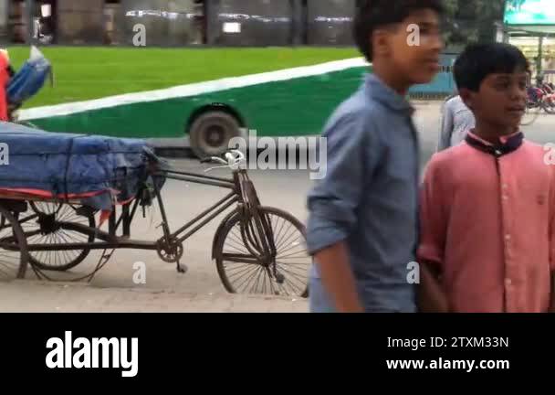 Unidentified people and street traffic at the Ring Road in the Adabor ...