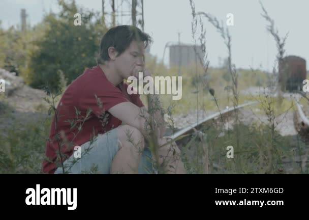 Sad young boy sitting on track and thinking. 4K Stock Video Footage - Alamy