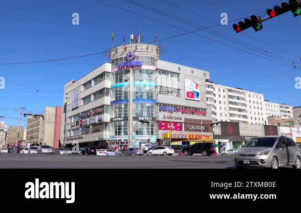 Street traffic at the Nomin Plaza, a large department store in Ulaanbaatar, the capital of ...