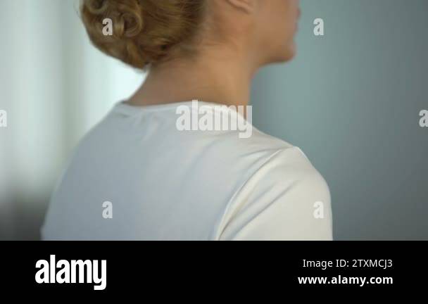 Woman suffering shoulder pinched nerve and massaging painful body part ...