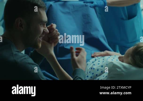 In the Hospital Woman in Labor Pushes and Gives Birth, Baby Comes out ...