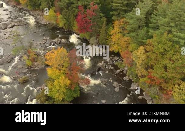 Beautiful Canadian nature scene in fall with river filmed by drone ...
