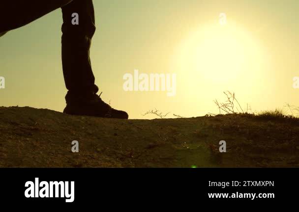 a courageous man-traveler, climbing to the top of a mountain, walking ...