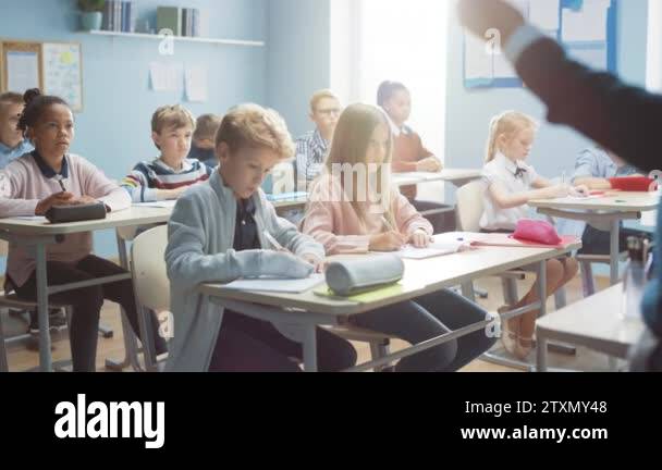 Elementary Classroom of Diverse Children Listening to the Teacher ...
