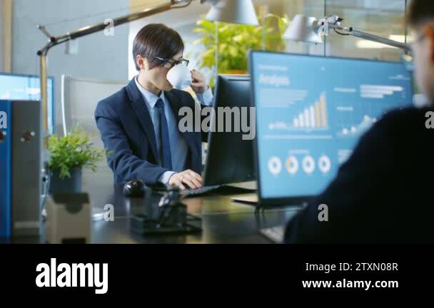 In the Office Agitated Businessman works on a Desktop Personal Computer ...
