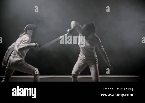 Fencing training - two young women having a duel between each other in ...