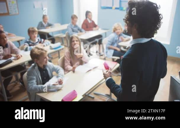 Elementary Classroom of Diverse Bright Children Listening to the ...