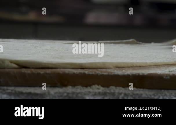 Hand throw a piece of dough. Scene. Man baking bread. Sprinkling some ...