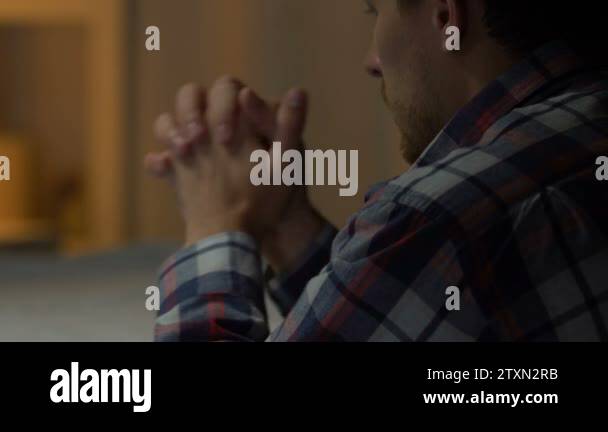 Sad man standing on knees and praying to God, problems in life, faith ...