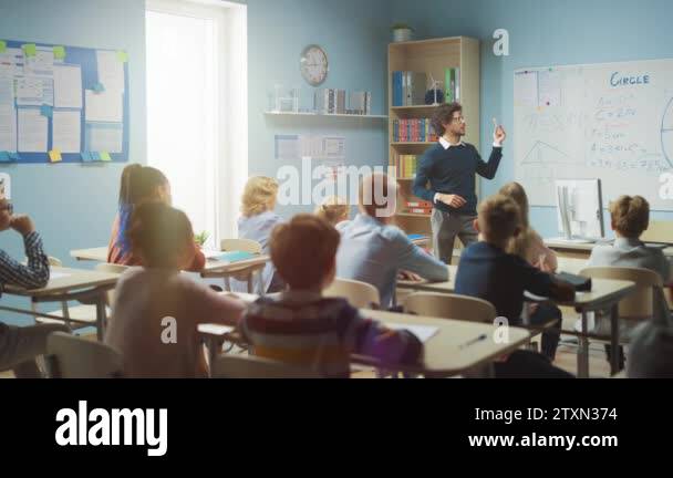 Caring Teacher Explains Lesson to a Classroom Full of Bright Diverse ...