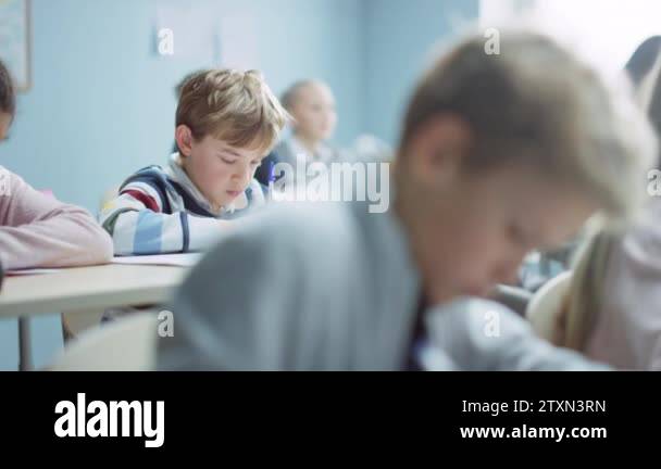 Elementary Classroom of Diverse Children Listening Attentively to their ...