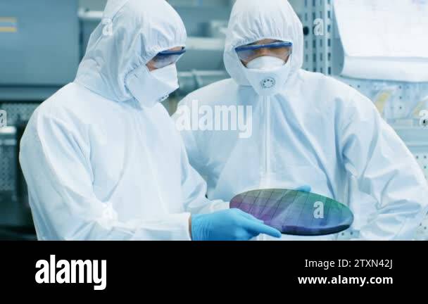 Two Scientists/ Technicians in Sterile Suits Check Semiconductor ...
