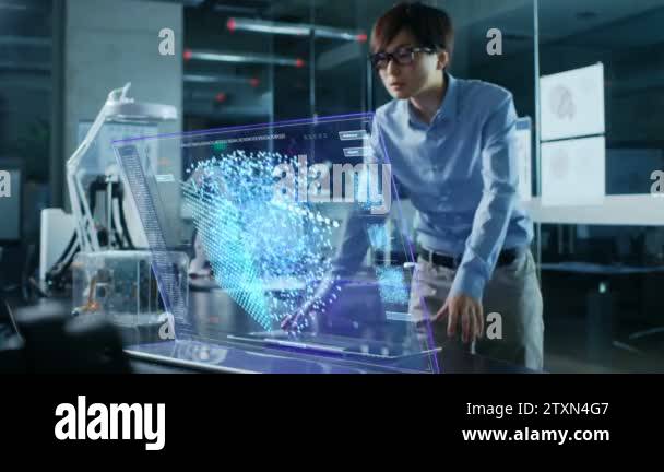 Asian Neural Network Engineer Uses Modern Computer With Transparent Holographic Display. Monitor ...