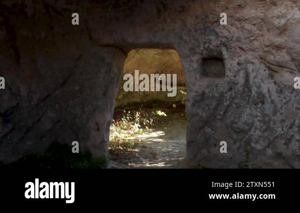 Ancient cave with door. Shot. Interior with hearth of ancient room in ...