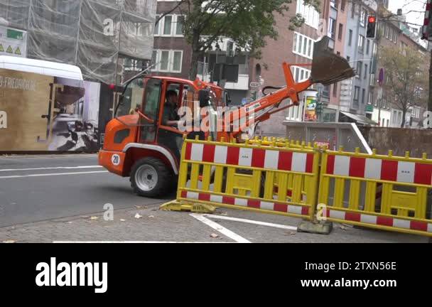 road workers conduct Orange excavators during road work. Excavator on ...