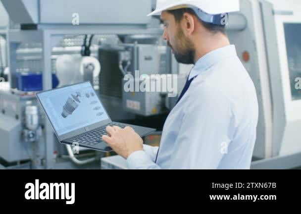 Engineer Working on a Laptop, He's Designing New Efficient Engine in ...