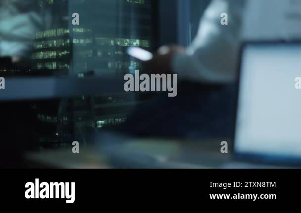 Man working in modern office late at night. White businessman at ...