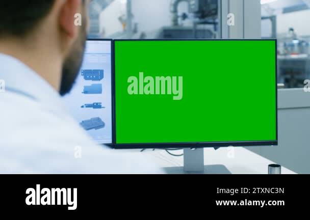 Engineer Working on a Personal Computer with Green Screen Mock-up ...