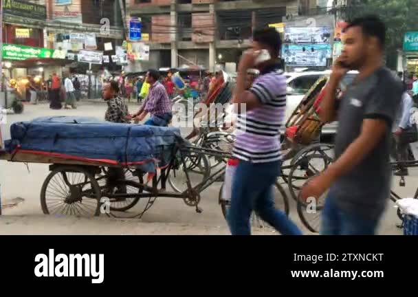 Unidentified people and street traffic at the Ring Road in the Adabor ...