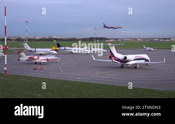 At the airport parking lot, aircraft are parked. Plane lands on the ...