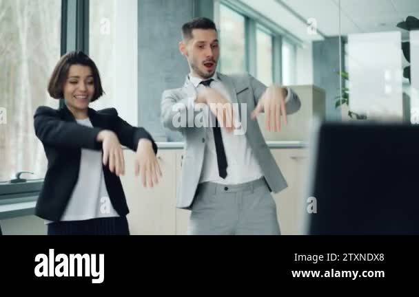 Careless office workers are relaxing at work dancing and laughing ...