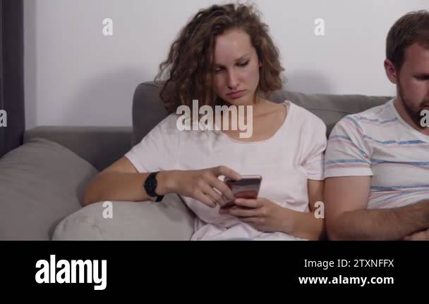 Diverse young people sitting in row on couch together obsessed with ...