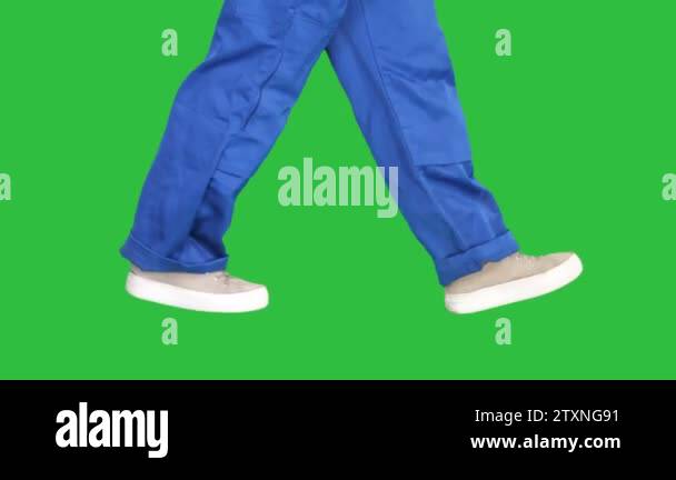 Legs of woman construction worker walking on a Green Screen, Chroma Key ...