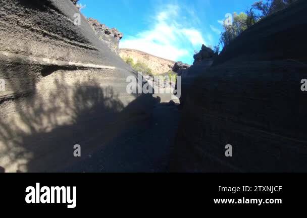 Walking inside volcano malacara grey debris, dry river of vocanic ...