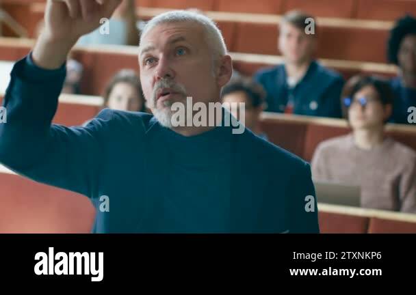 Camera Facing Class: Prominent Professor Writing on the Blackboard and ...