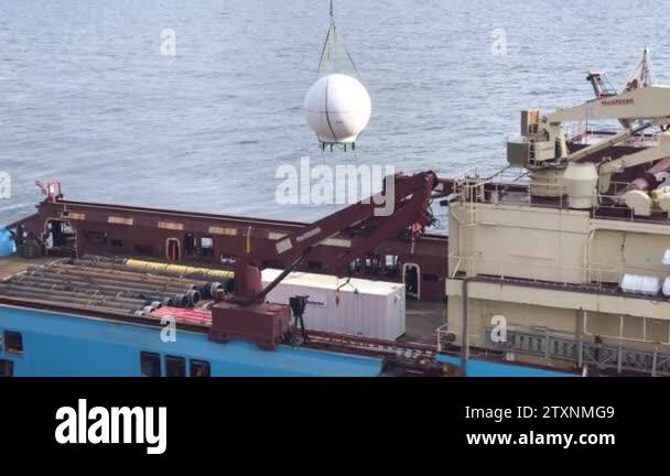 Offshore drilling rig crane engage in cargo operations with a supply ...