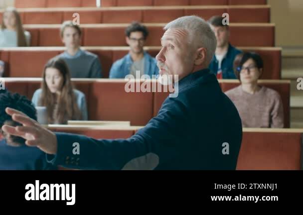 Camera Facing Class: Prominent Professor Writing on the Blackboard and ...
