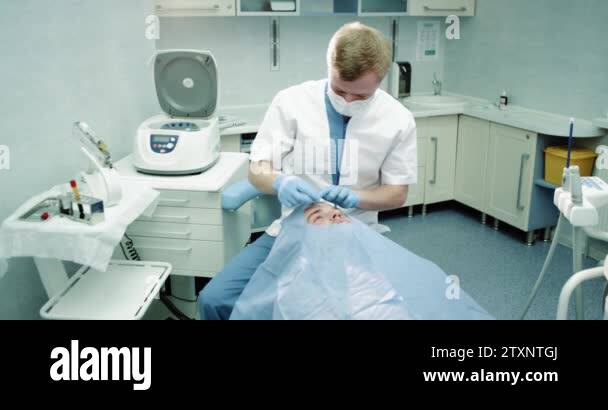 Vampire facelift procedure in a modern clinic doctor starting the ...