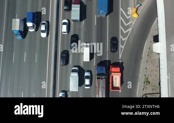 The camera is moving over the flow of cars on the freeway. Movement on ...
