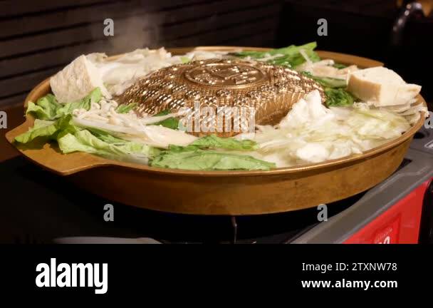 Motion of hot pot boiling and people eating food inside Chinese ...