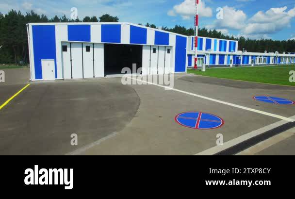 4k front view of airplane shed with doors shutting after flight private ...