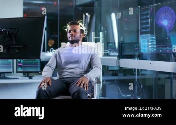 Man Wearing Brainwave Scanning Headset Sits in a Chair while Watching ...