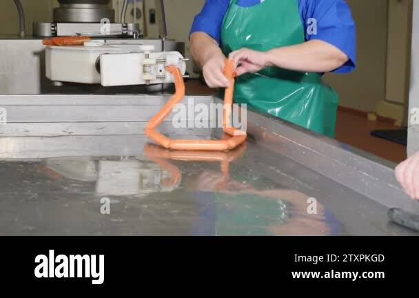 Industrial sausages production process at meat and sausage making plant ...