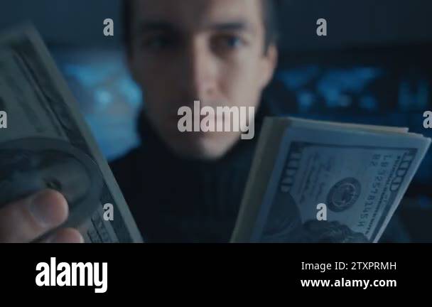 Portrait of Hacker Programmer counts Money earned ith criminally on ...